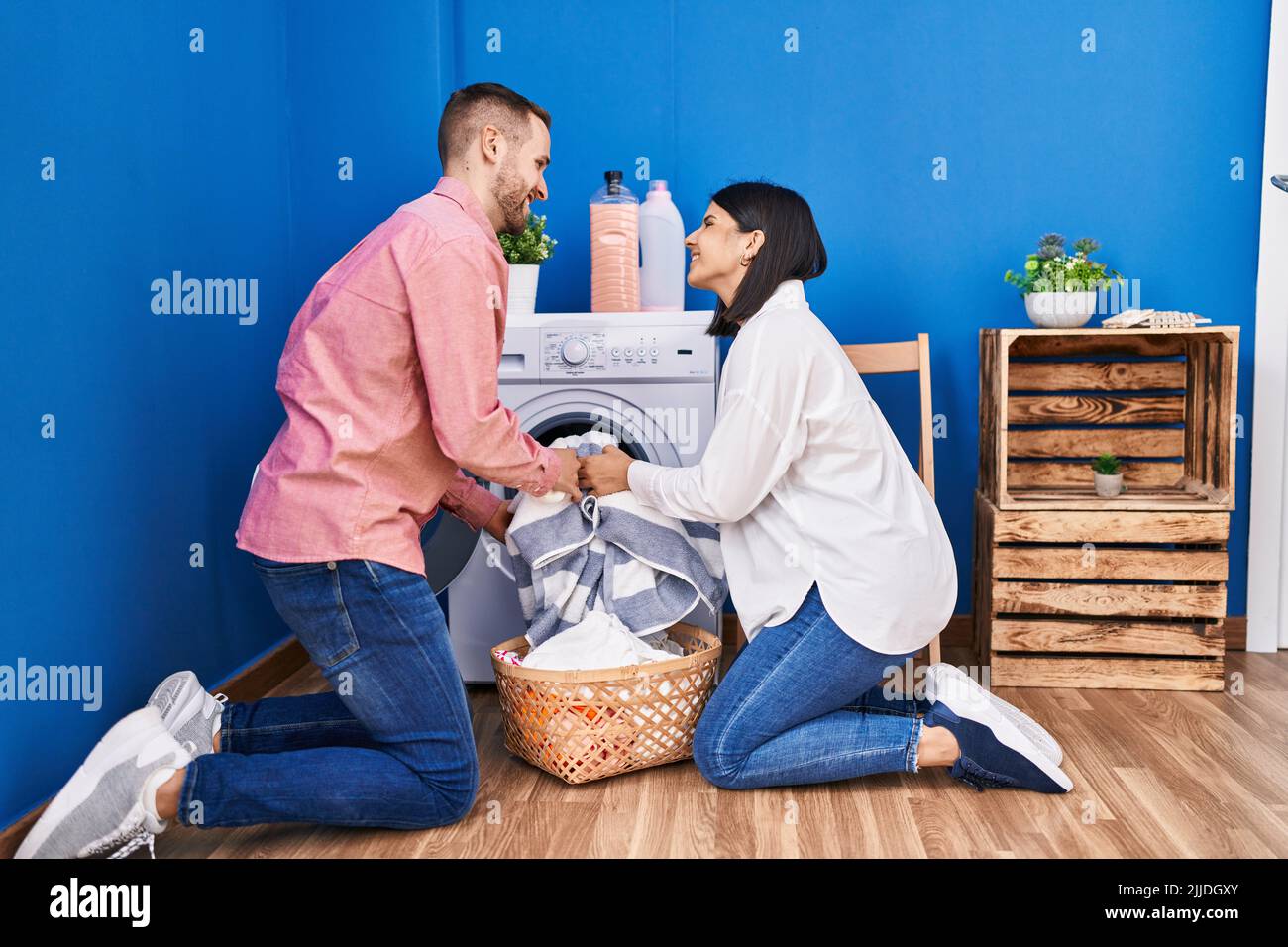 Man and woman couple washing clothes at laundry room Stock Photo - Alamy