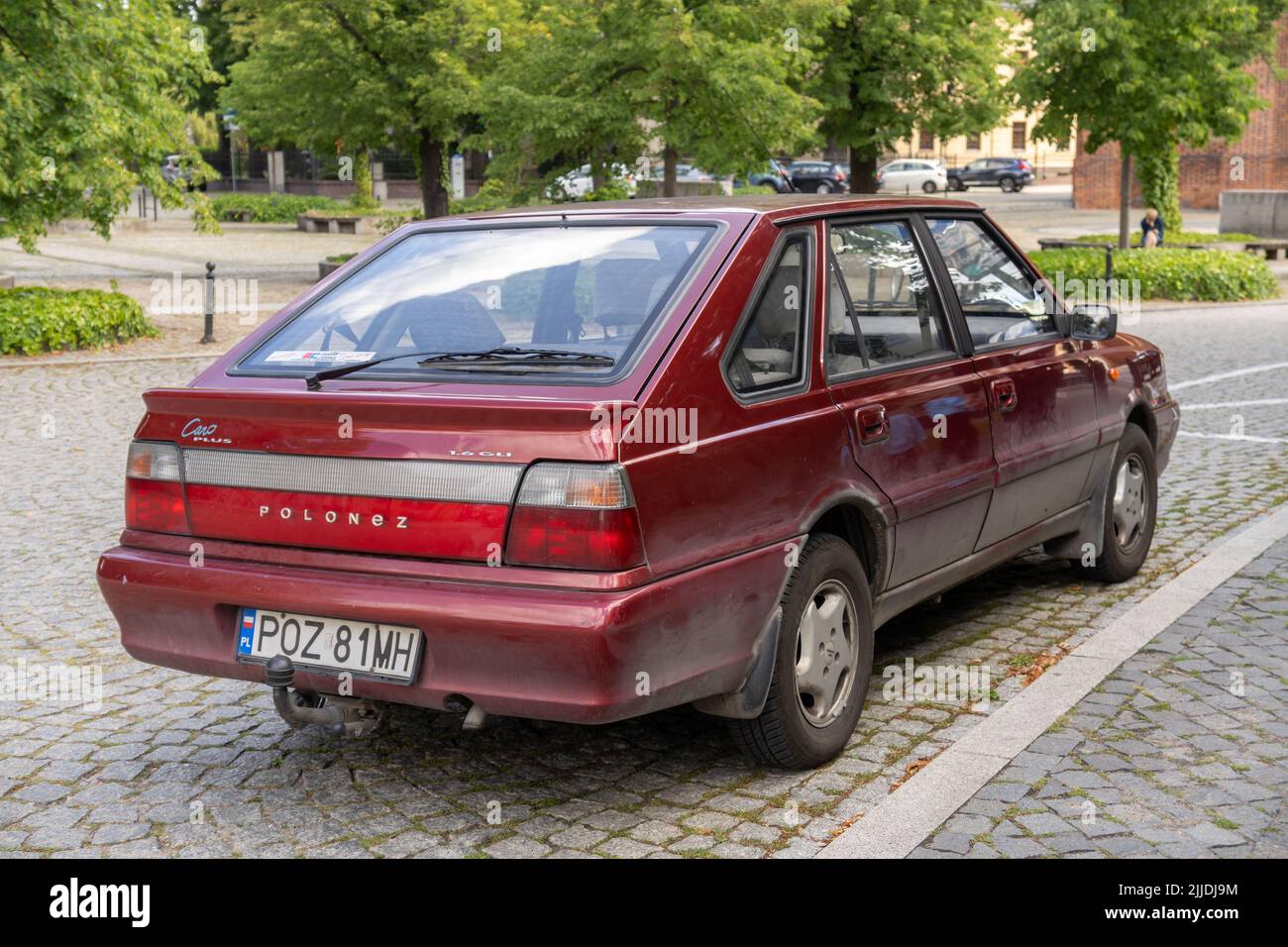 An old red Polonez car parked in the street with cobblestone Stock ...