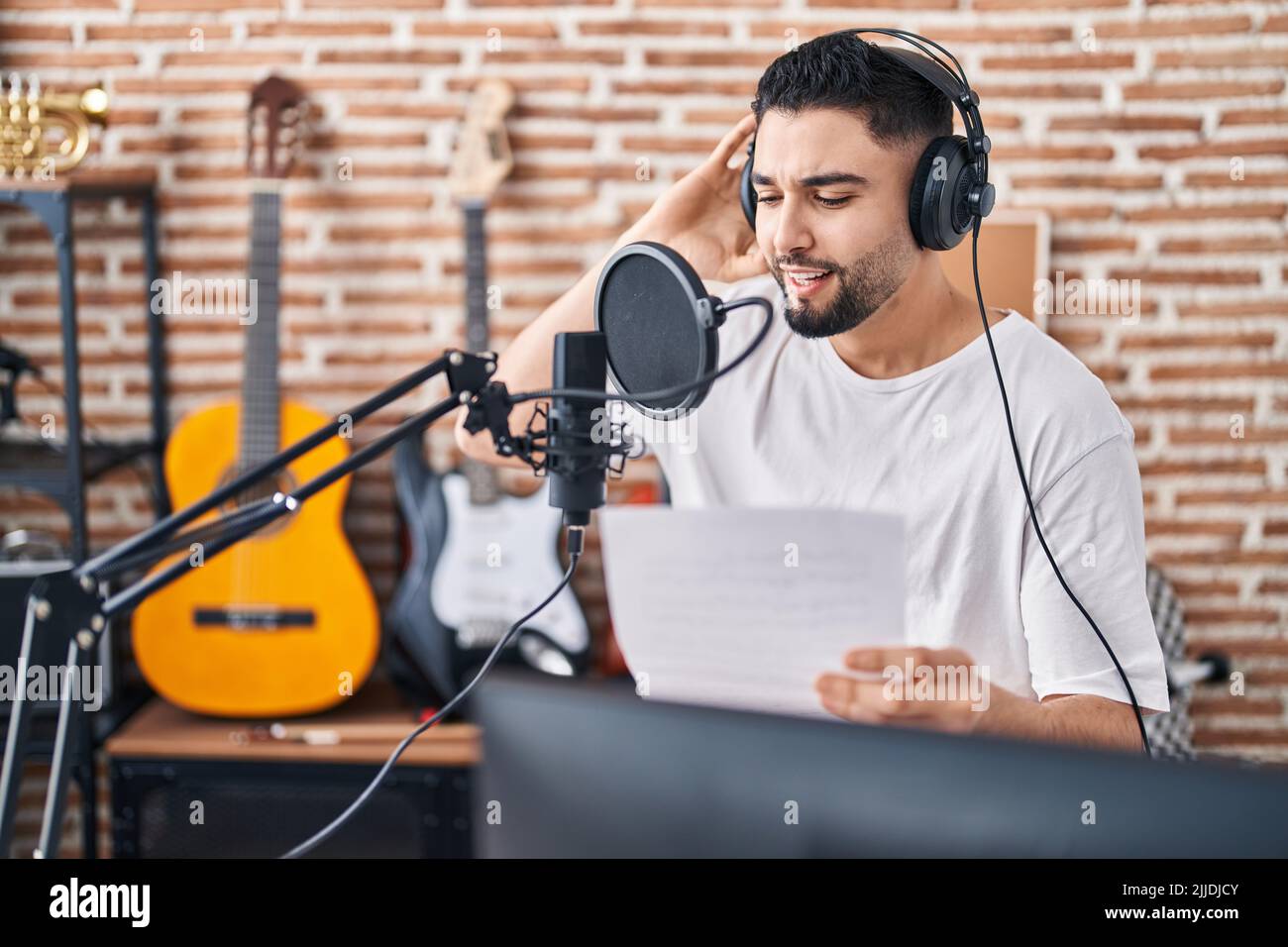 Young arab man artist singing song at music studio Stock Photo - Alamy