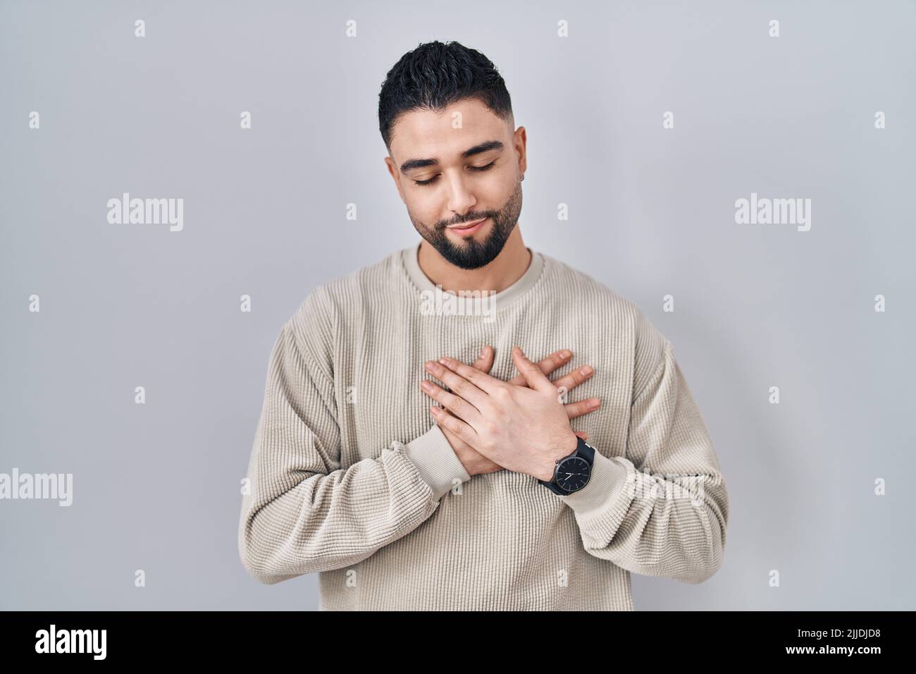 Young handsome man standing over isolated background smiling with hands ...