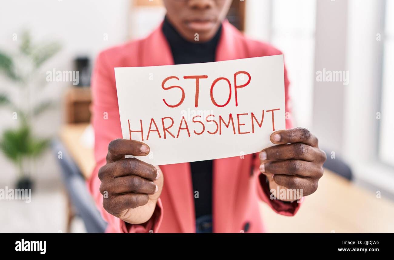 African american woman business worker holding stop harassement banner ...
