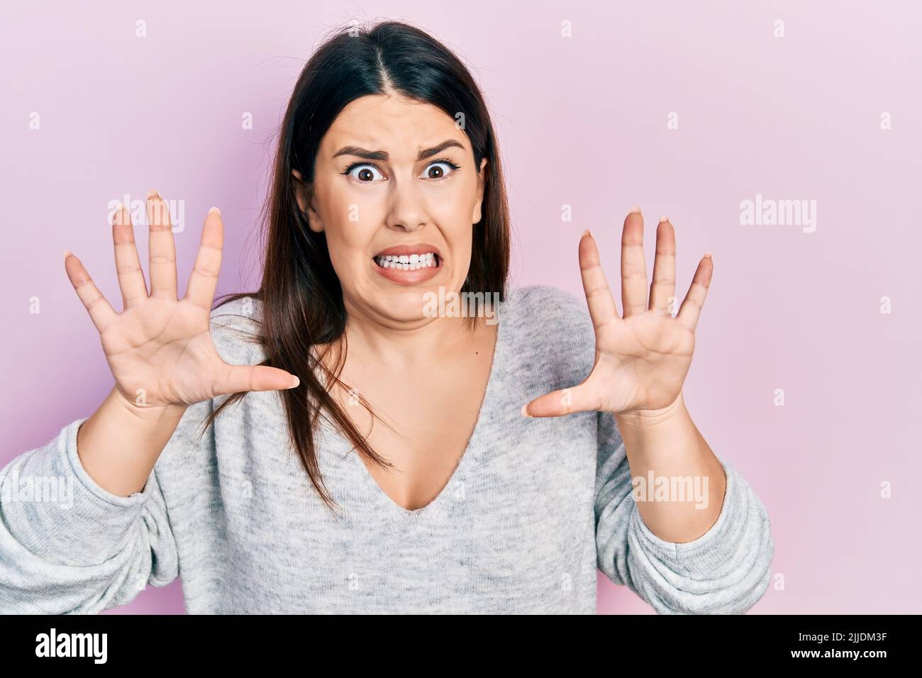 Young Hispanic Woman Wearing Casual Clothes Afraid And Terrified With