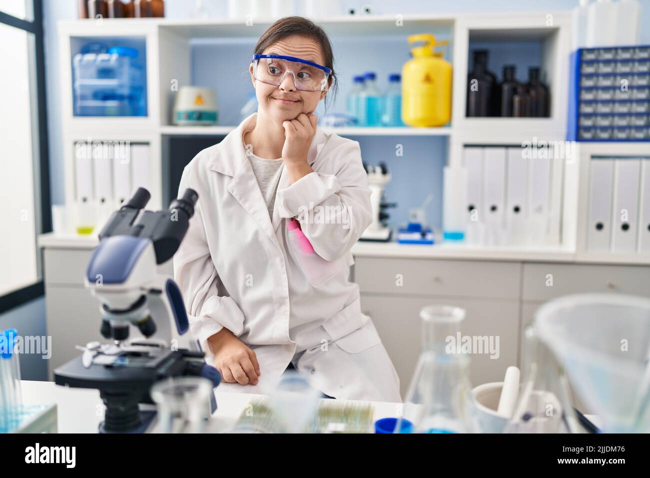 Hispanic girl with down syndrome working at scientist laboratory ...