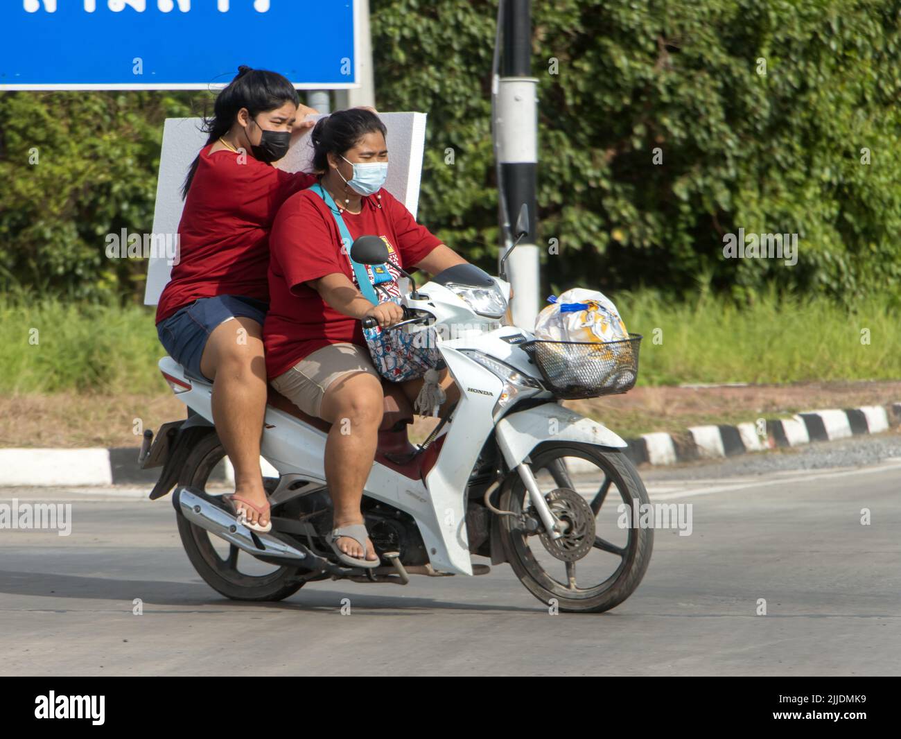 THAILAND, JUNE 11 2022, Two women carry a load on a motorcycle Stock ...