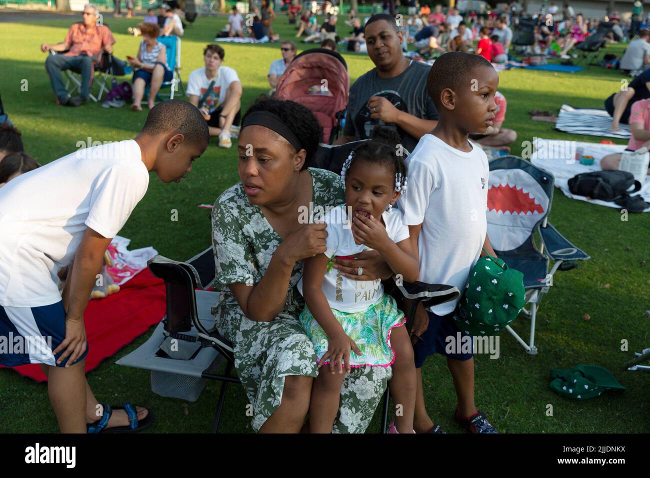 People outdoors on the Esplanade for a summer concert by the Boston ...