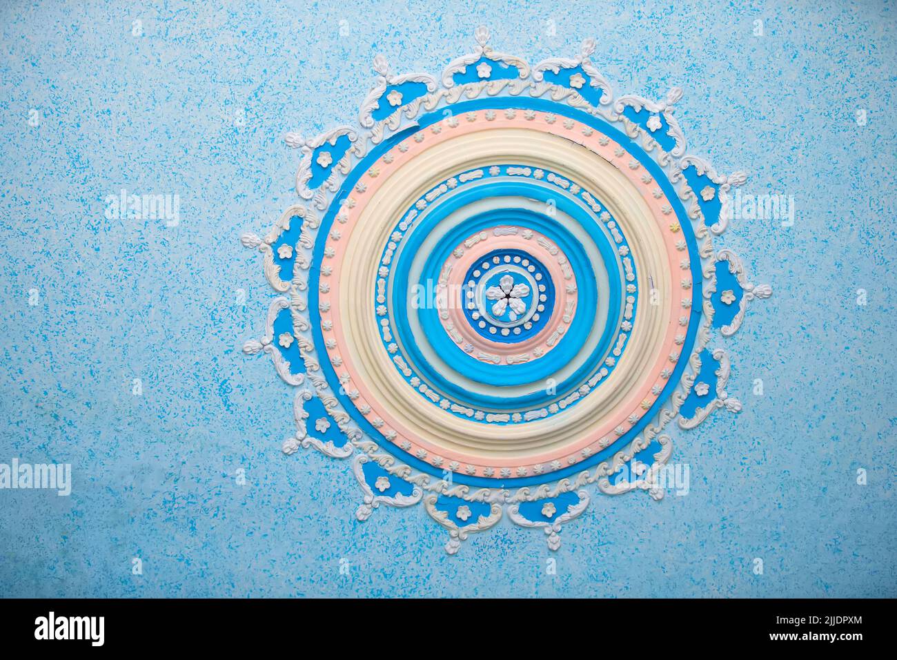 Round beautiful stucco pattern on the ceiling. Relief plaster, relief ...