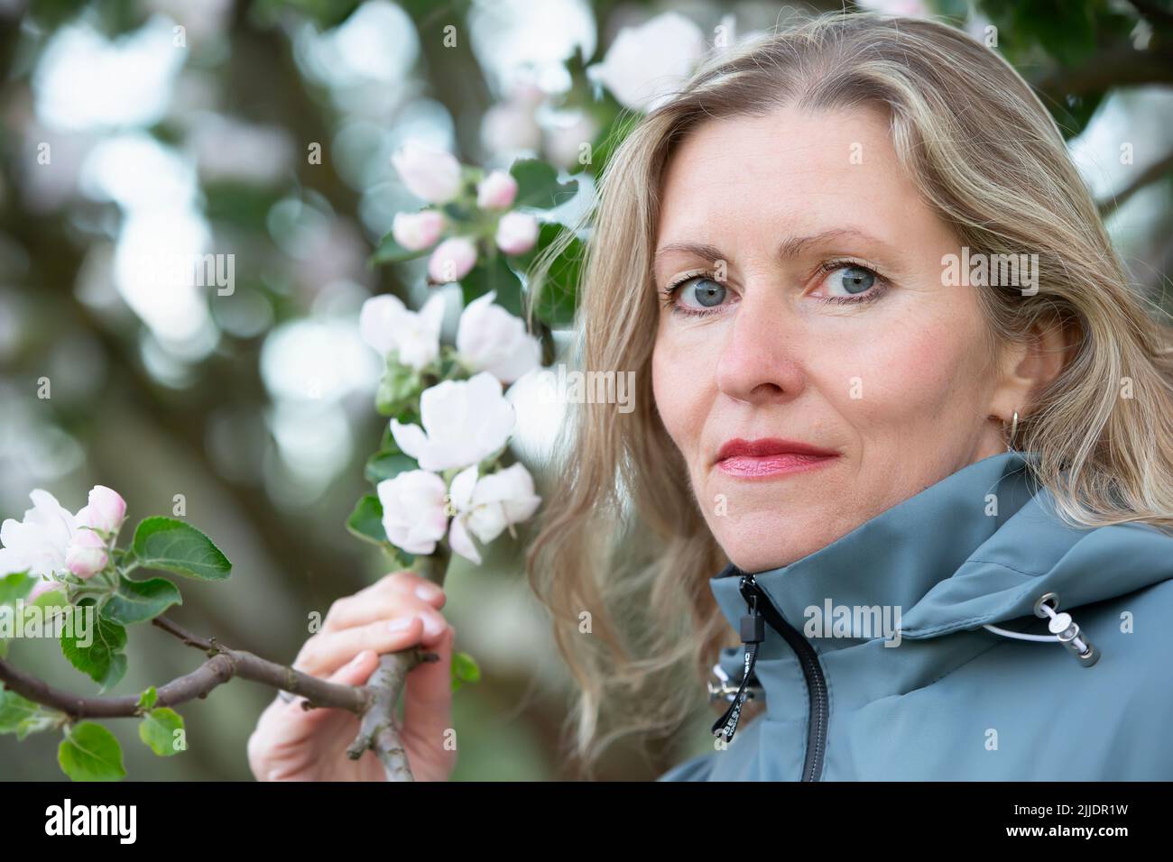 Close-up portrait of happy elderly beautiful woman posing in spring ...