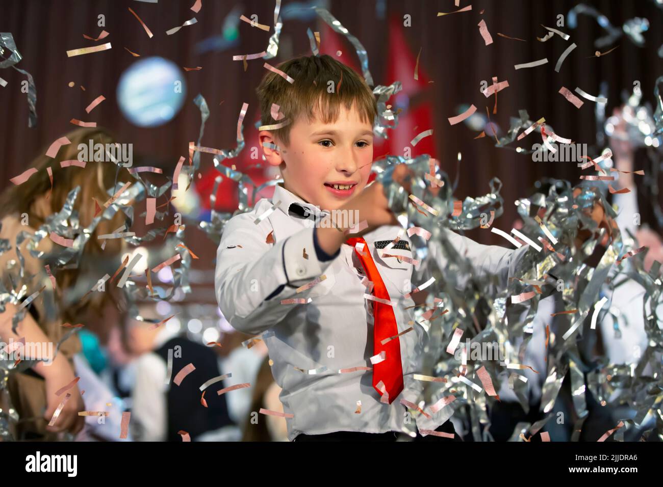 Happy little boy in confetti.Magic time - Portrait of a very happy ...