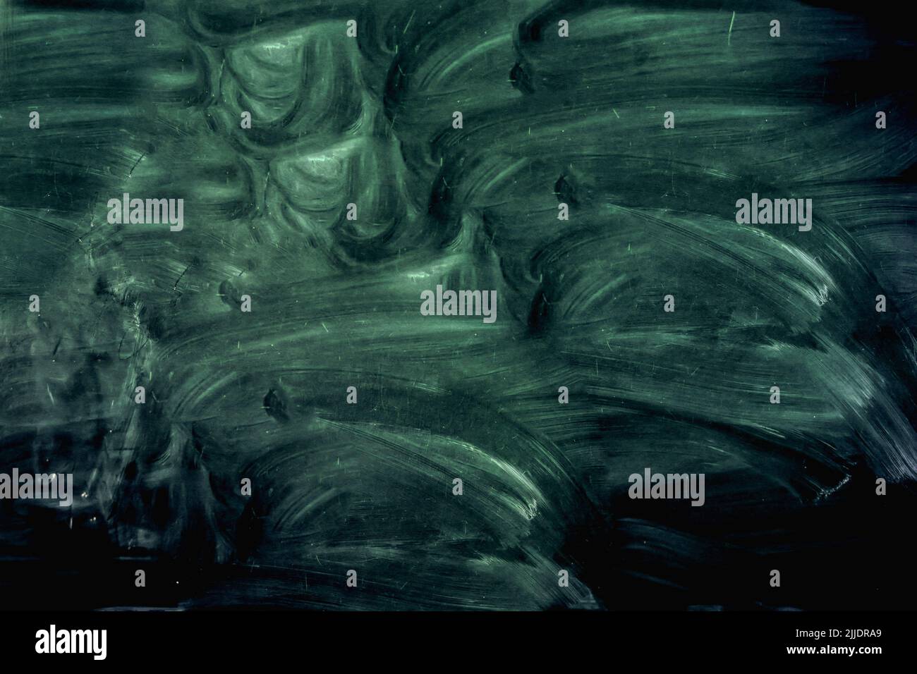 Dark green vintage background of blurred paint spots with cracks and ...