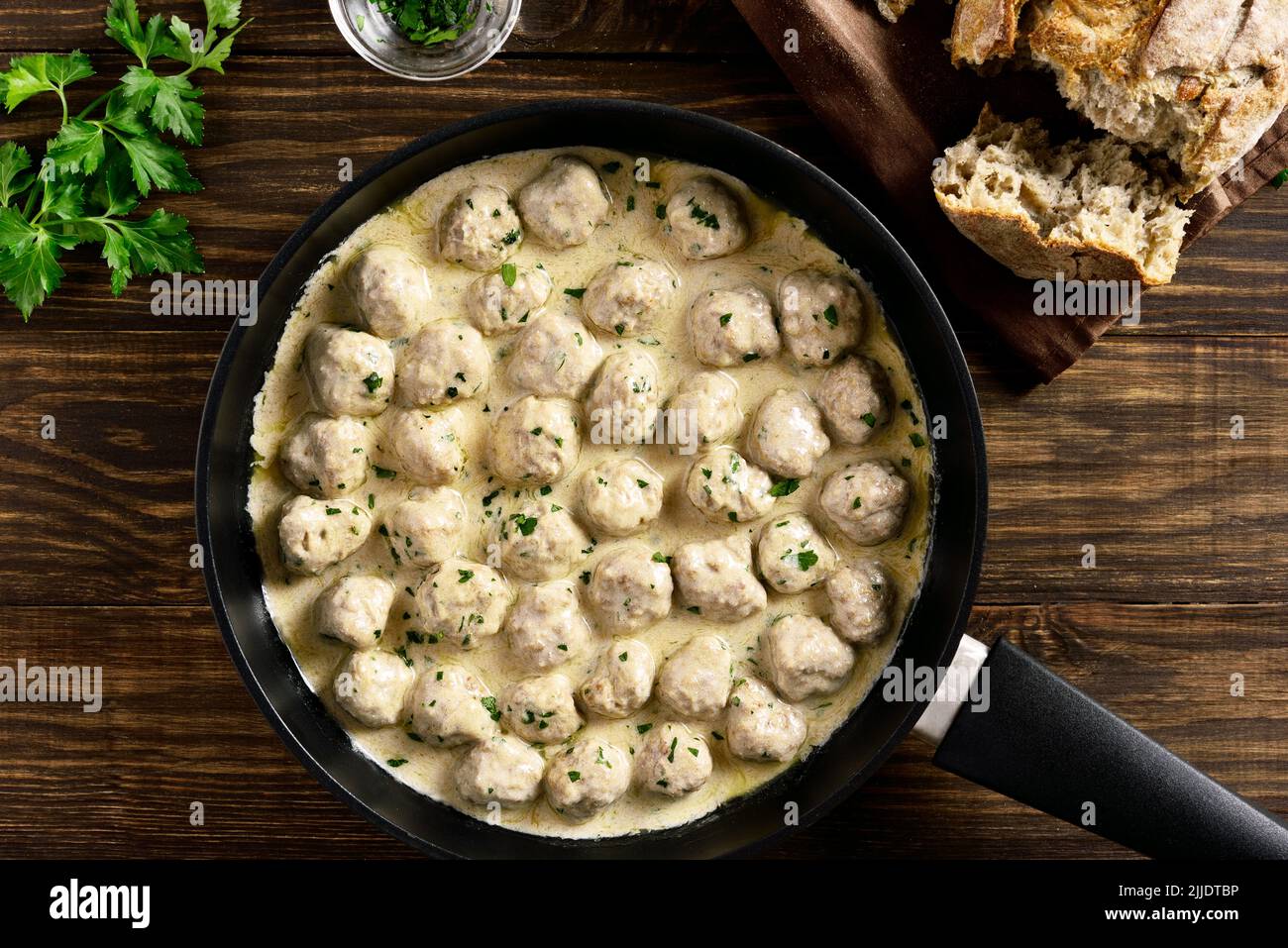Homemade swedish meatballs with creamy white sauce in cooking pan over ...