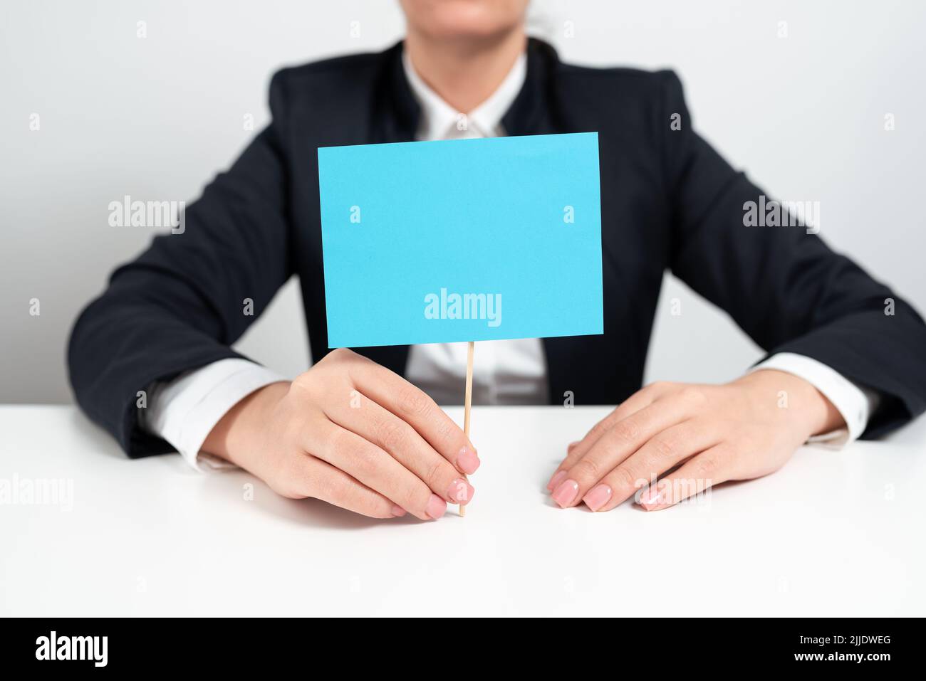 Businesswoman Presenting Important Message On Paper Attached To Stick ...
