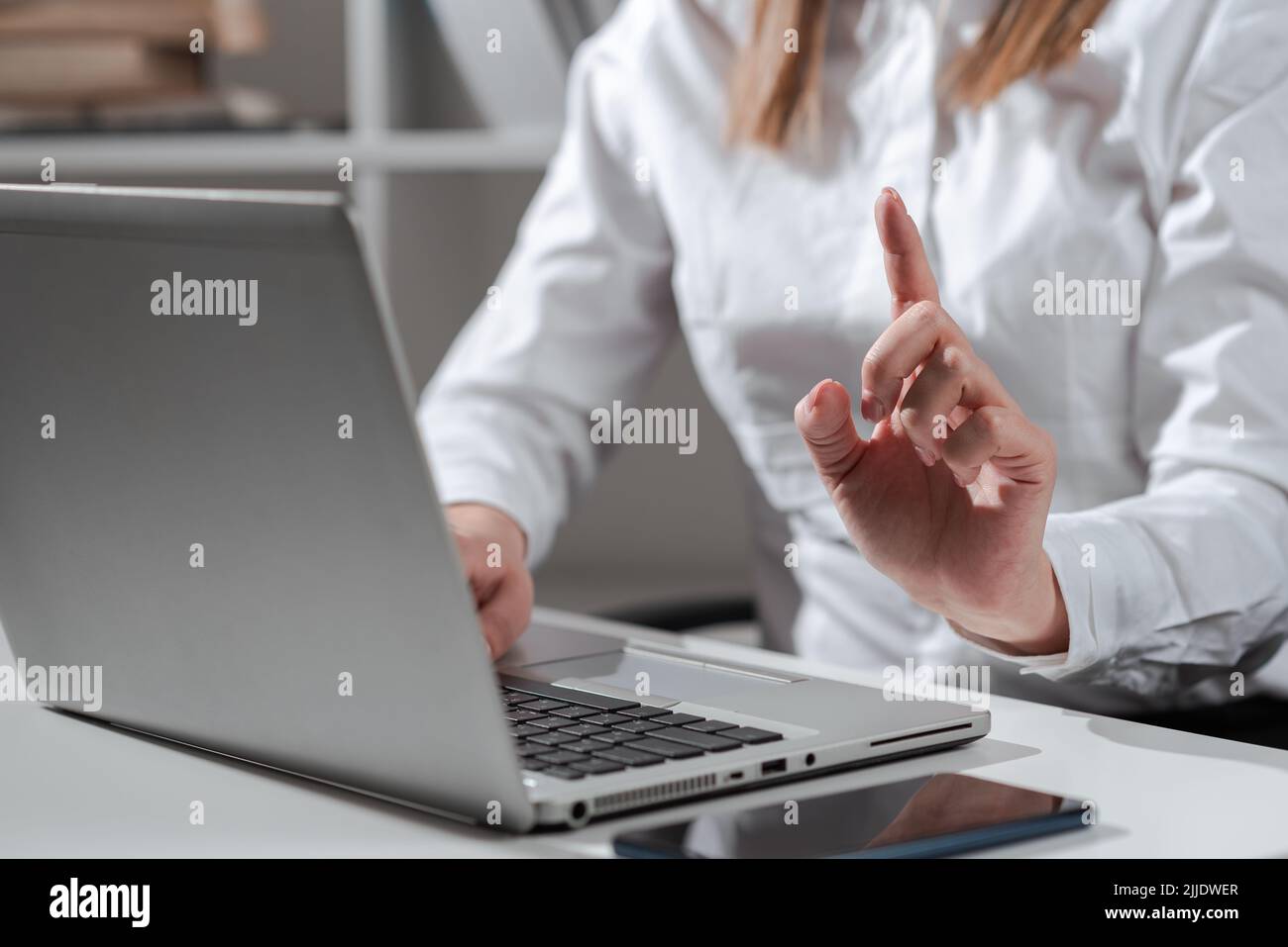 Woman Typing Updates On Lap Top And Pointing New Ideas With One Finger ...