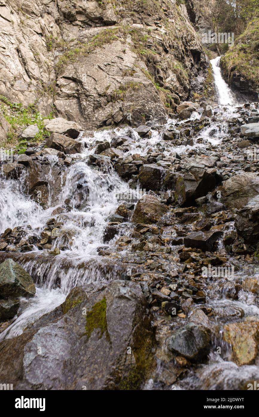 .the mountain river flows quickly over the stones Stock Photo - Alamy