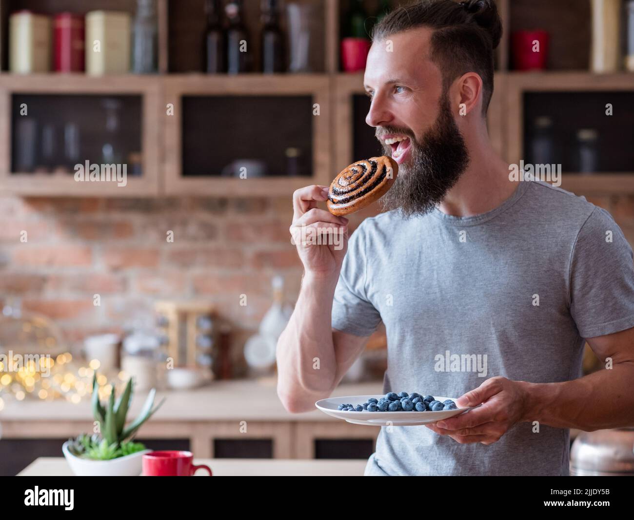 pastry baked food man kitchen eat poppy seed bun Stock Photo - Alamy