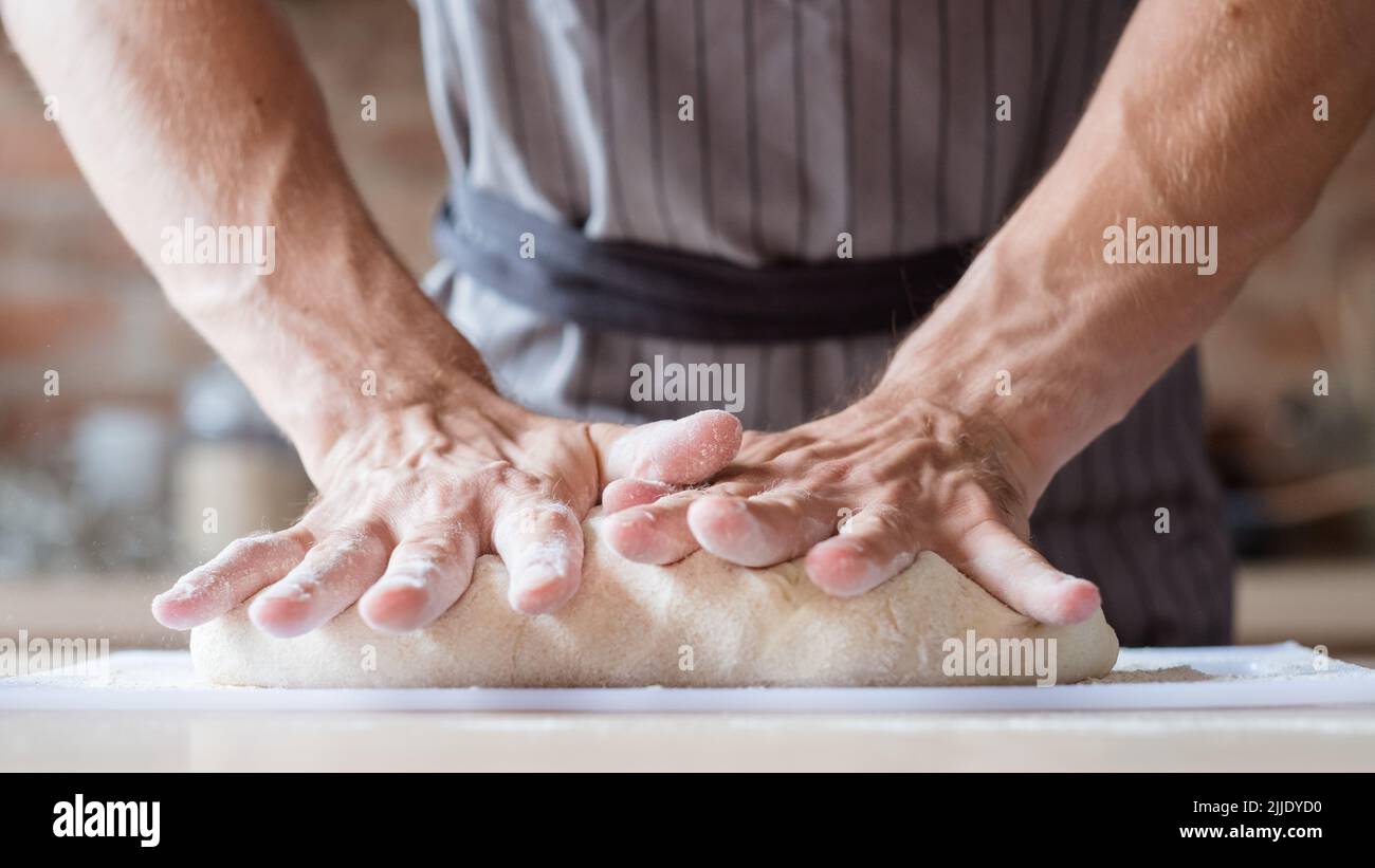 food pastry baker preparing man kneading dough Stock Photo - Alamy