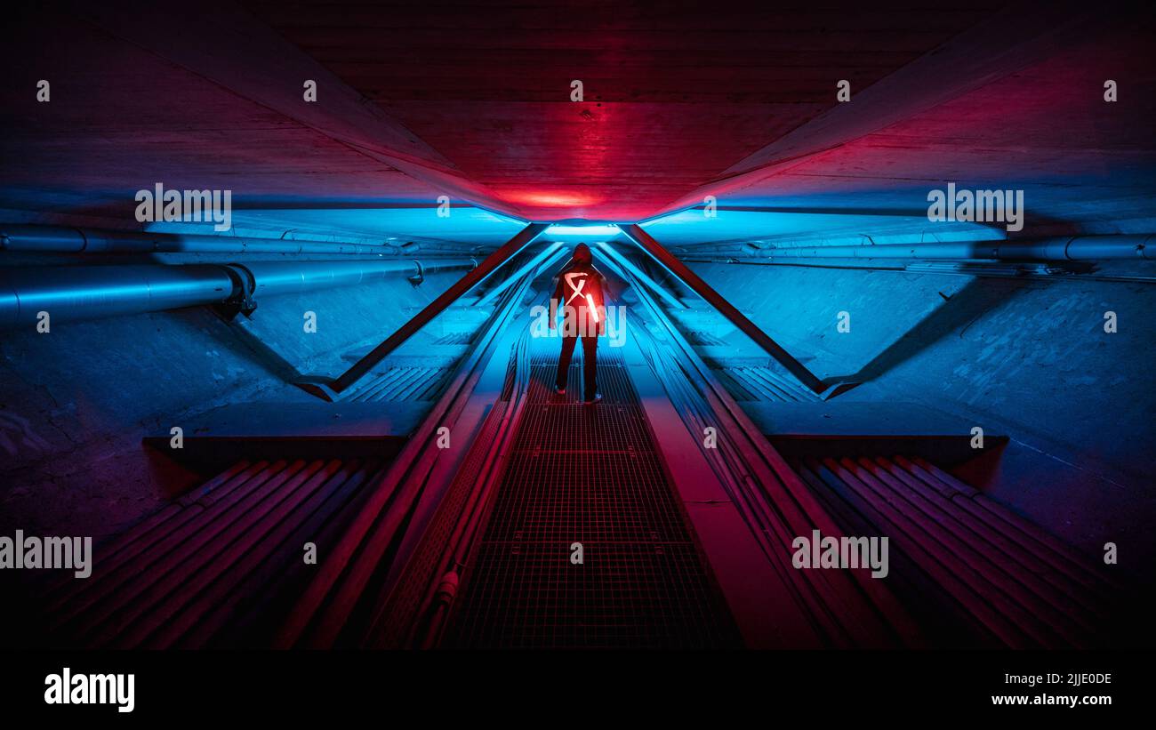 A dramatic shot of a man in a standoff using red light sword Stock ...