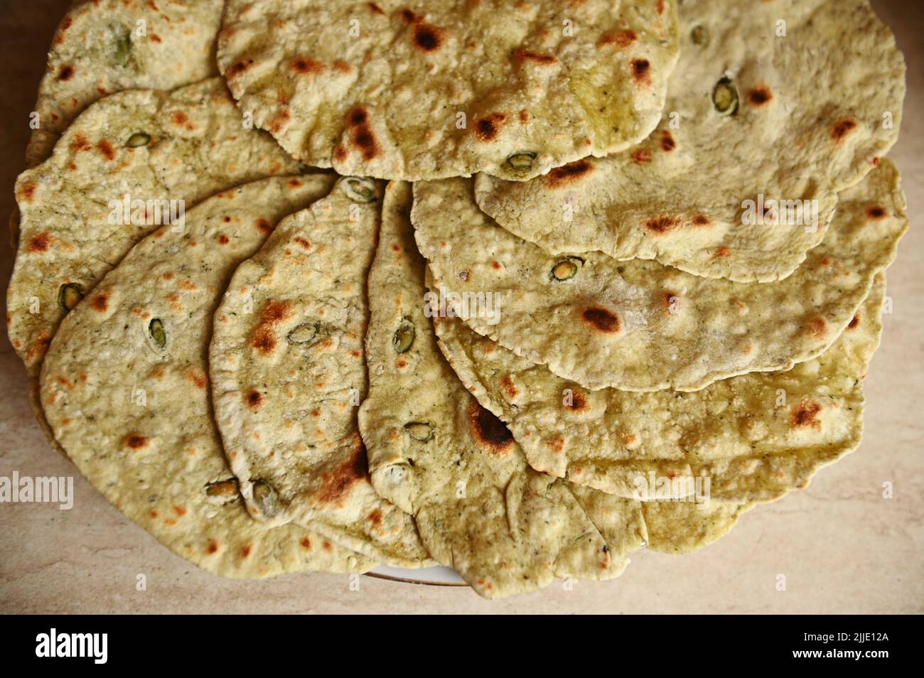 Close-up. Top view of round shaped pita bread stacked on a plate ...
