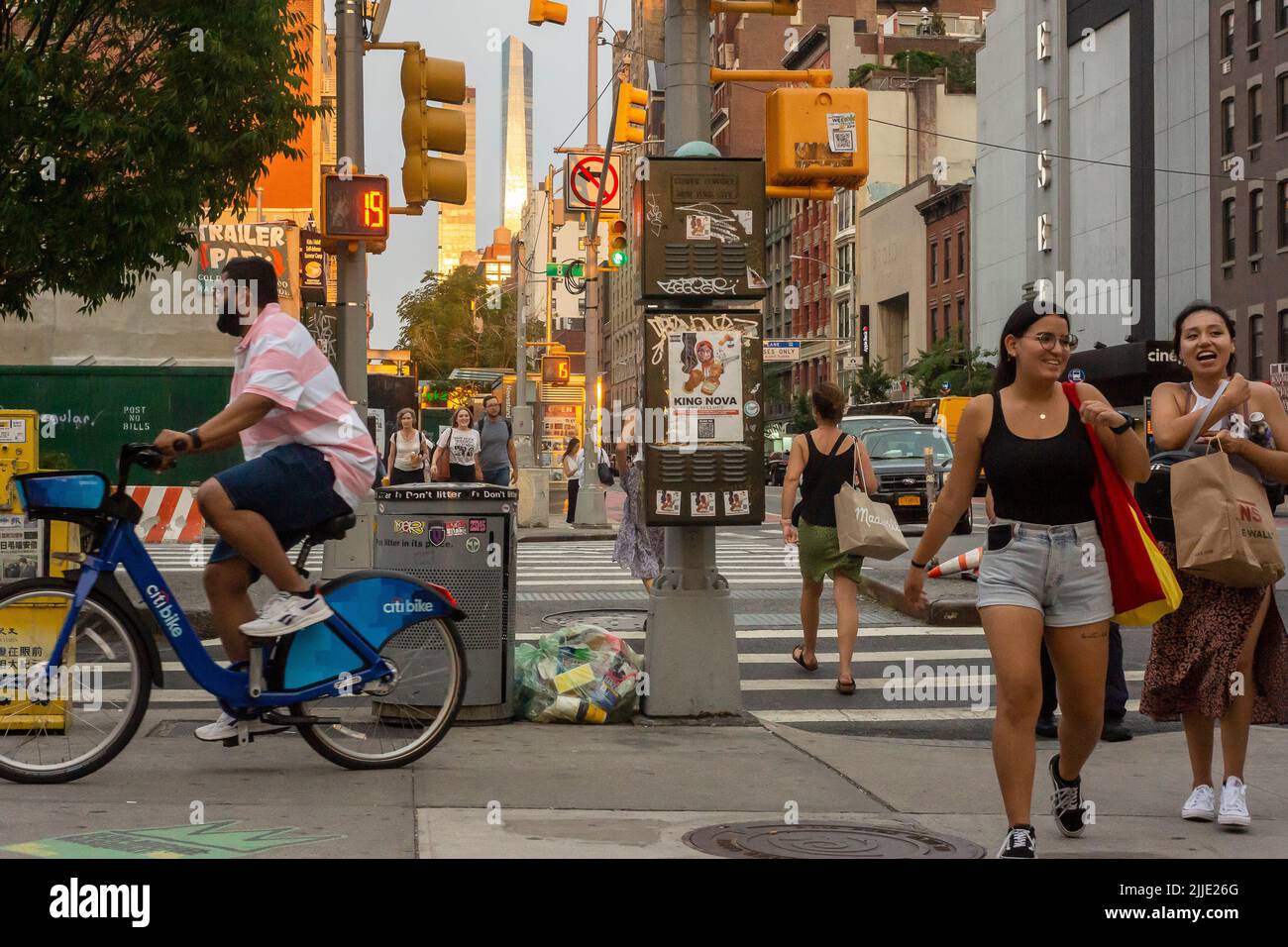 Busy Chelsea street corner of West 23rd Street and Eighth Avenue in New ...