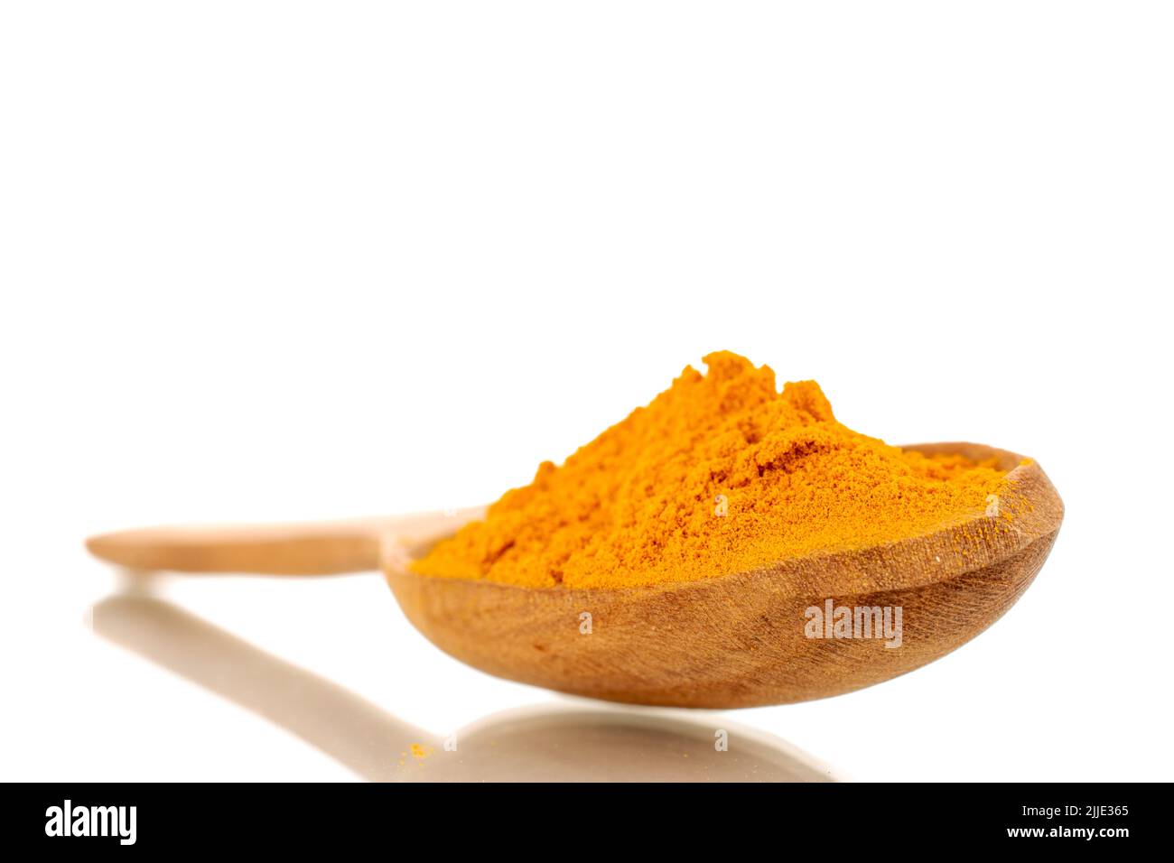 Aromatic bright yellow spice turmeric with a wooden spoon, close-up ...