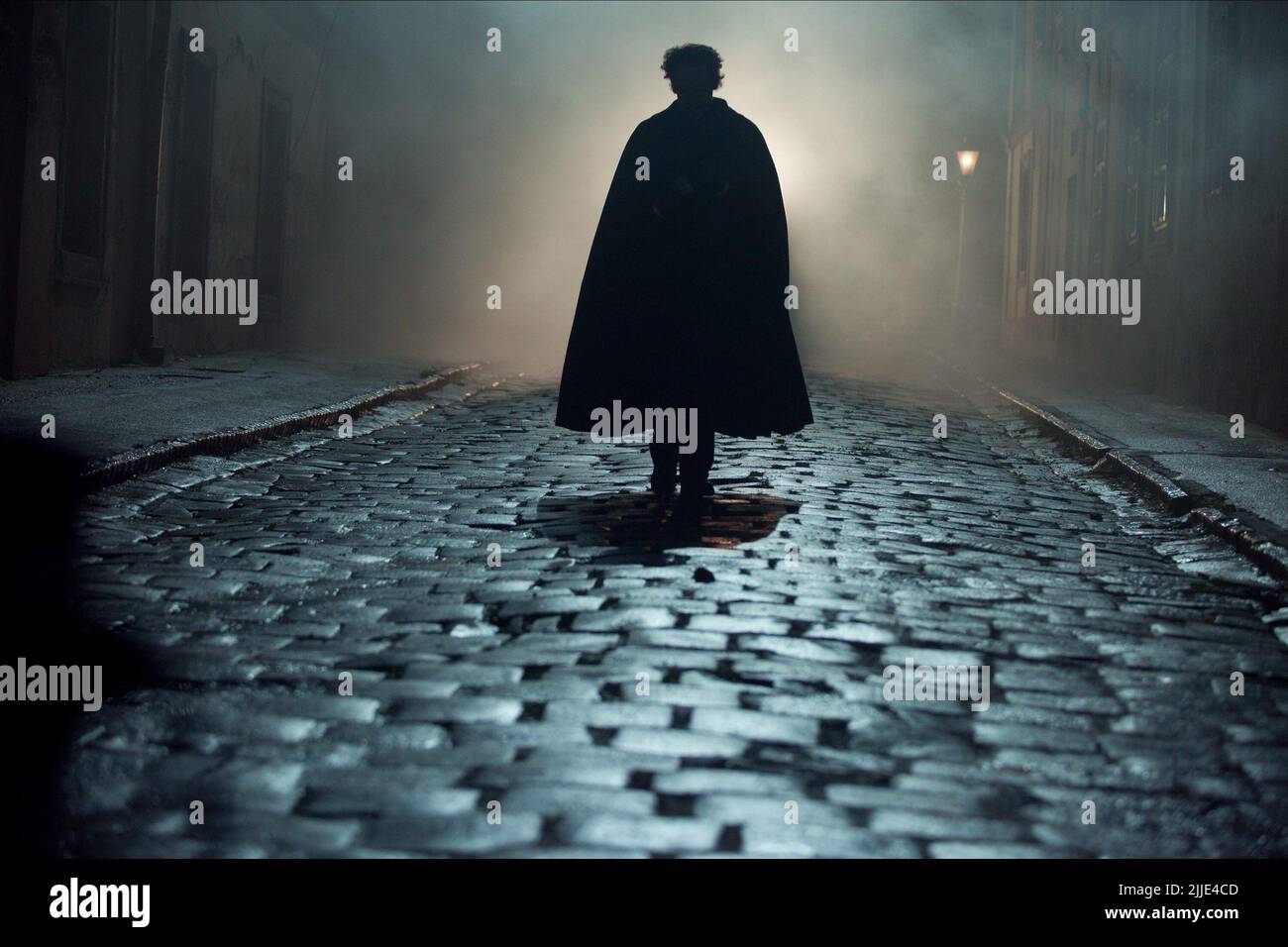 CAPED FIGURE WALKS COBBLED STREET, THE RAVEN, 2012 Stock Photo - Alamy