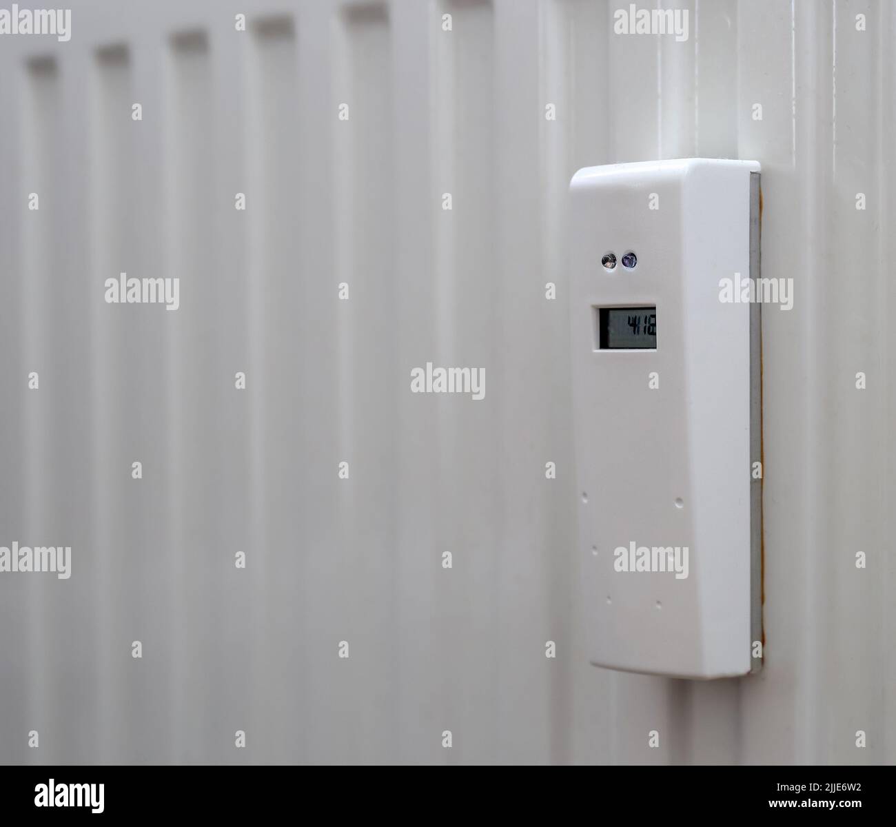 White heat meter hanging on the radiator in Poland Stock Photo - Alamy