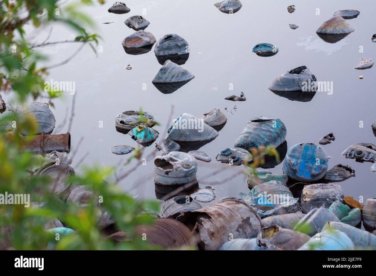 A various objects thrown into the lake with which the environment is ...
