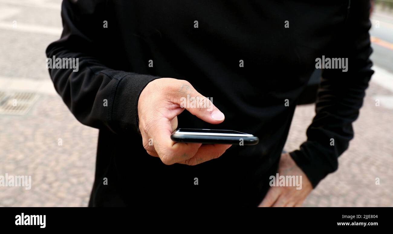 Hispanic man using cellphone in street downtown, real people, latin guy ...