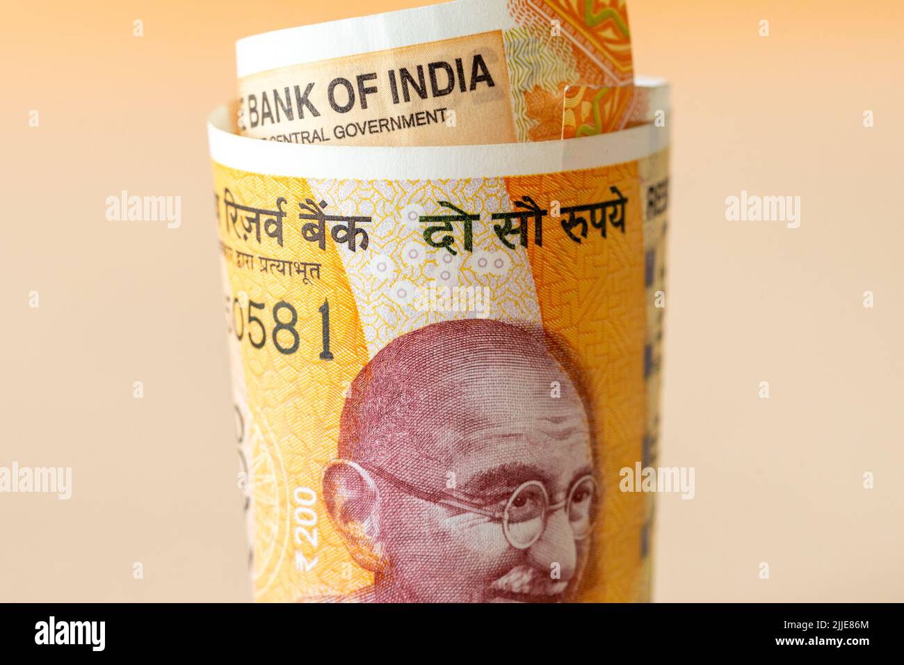 A rolled up roll of Indian money, New 200 rupee banknotes, financial ...