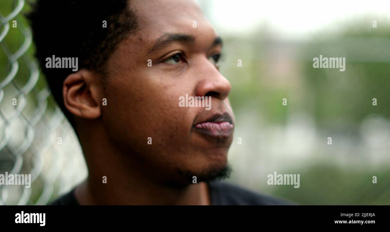 Stressed African man thinking outside. young black guy having doubts ...