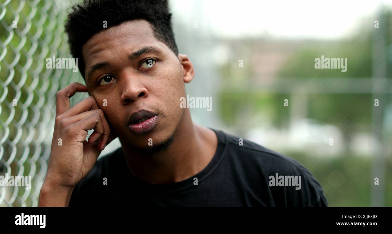 Stressed African man thinking outside. young black guy having doubts ...
