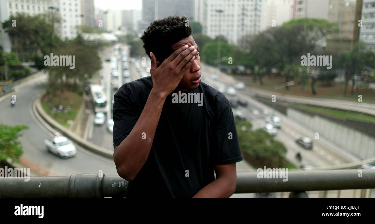Stressed black African man standing in downtown city feeling anxiety ...