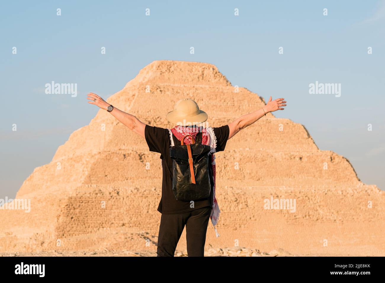 back view of woman standing in front of the step pyramid at Saqqara ...