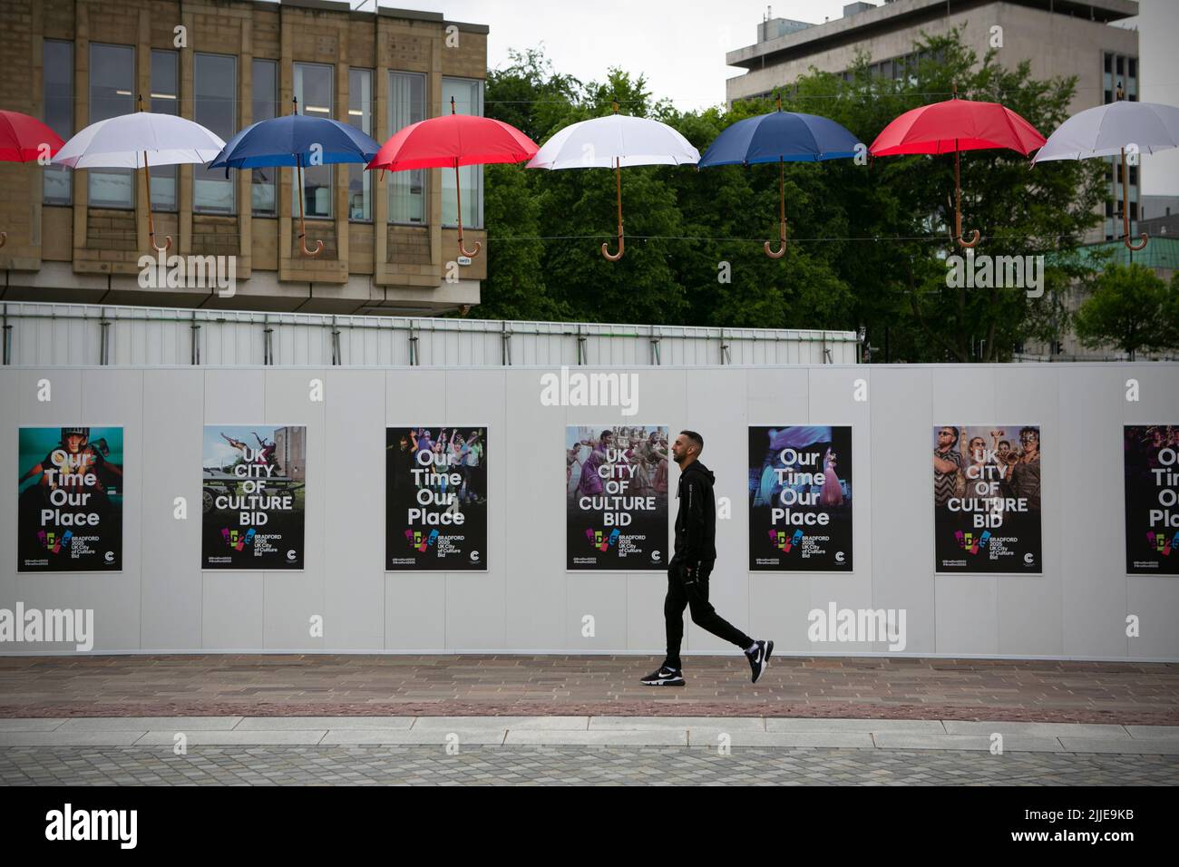 A man strolls past Bradford 2025 UK City of Culture banners in Bradford ...