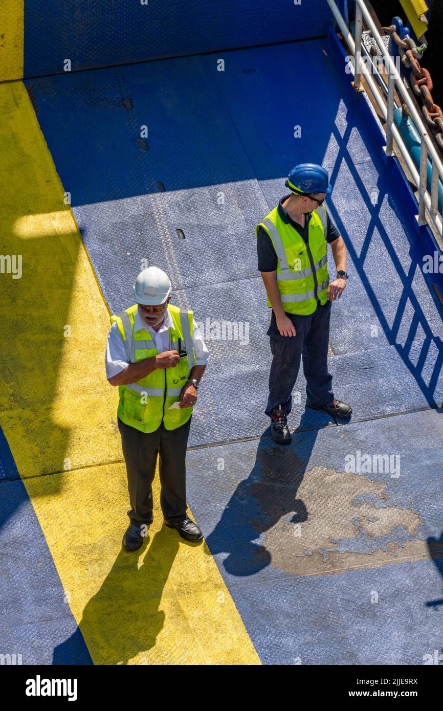 workers on the isle of wight ferry marshalling the traffic on and off ...