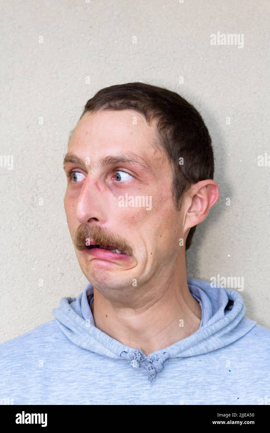 Portrait of young terrified and scared man isolated on gray background ...