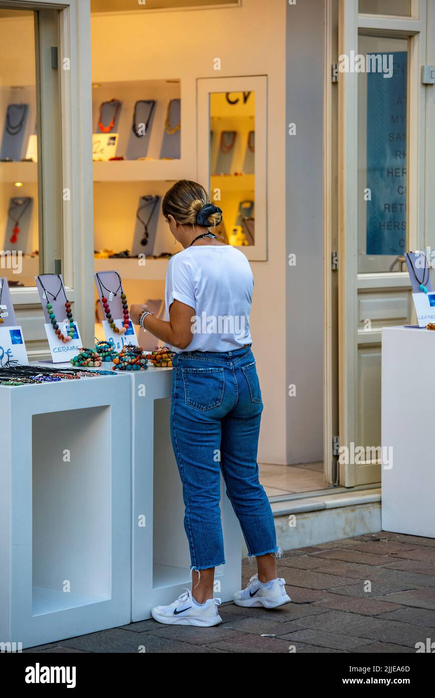 young woman looking at jewellery on display at a shop in the high ...