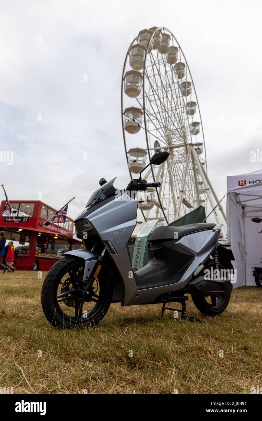 Electric moped and big wheel at car fest Stock Photo - Alamy