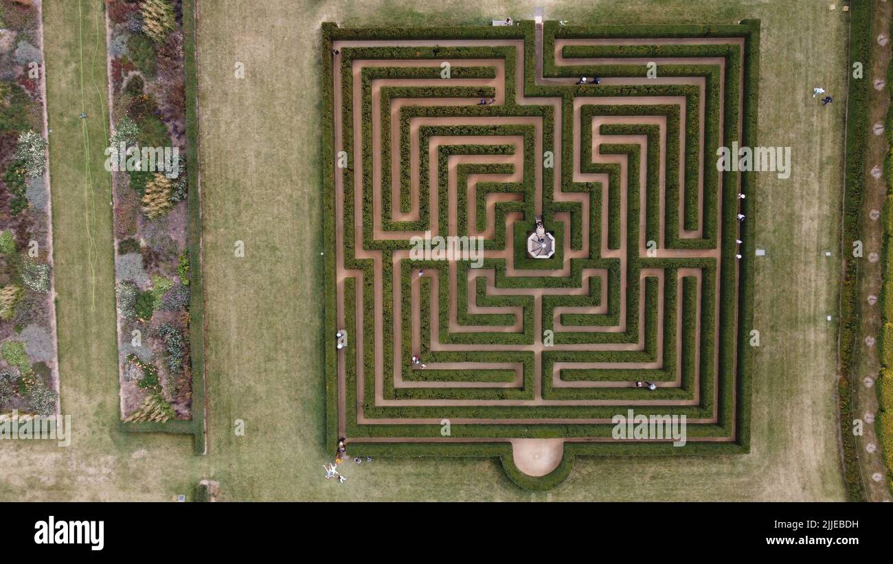 An aerial shot of a square maze in a garden with flower lanes on the ...