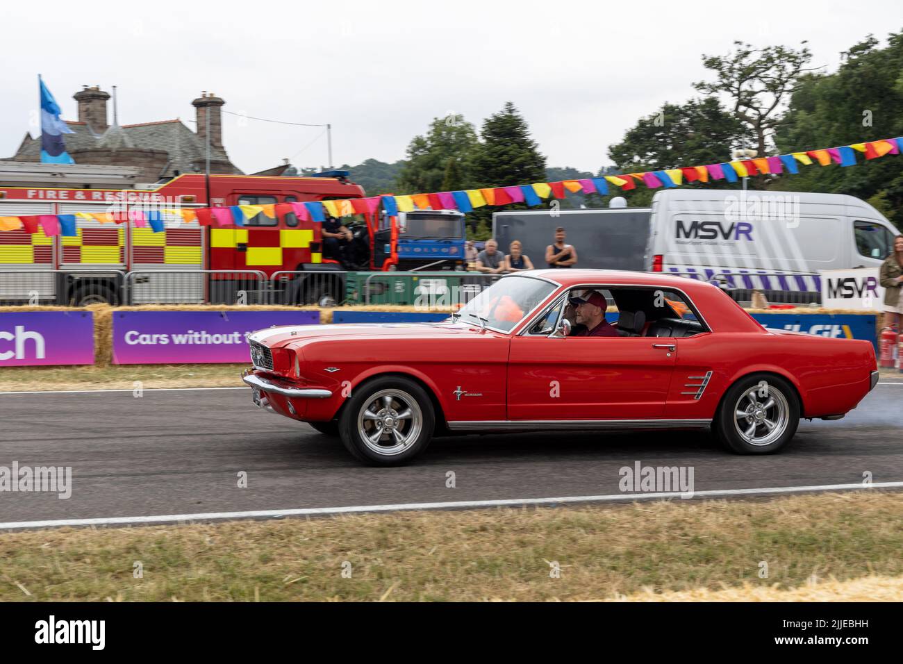 Cars on the track at CarFest Stock Photo - Alamy