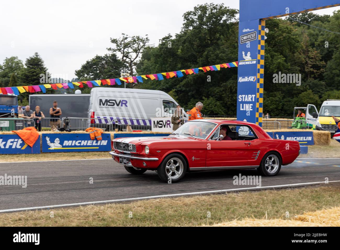 Cars on the track at CarFest Stock Photo - Alamy