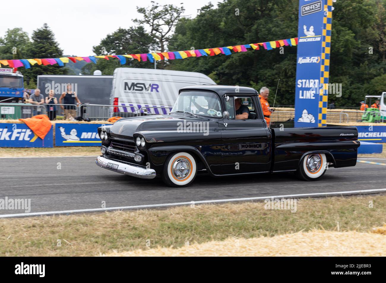 Cars on the track at CarFest Stock Photo - Alamy