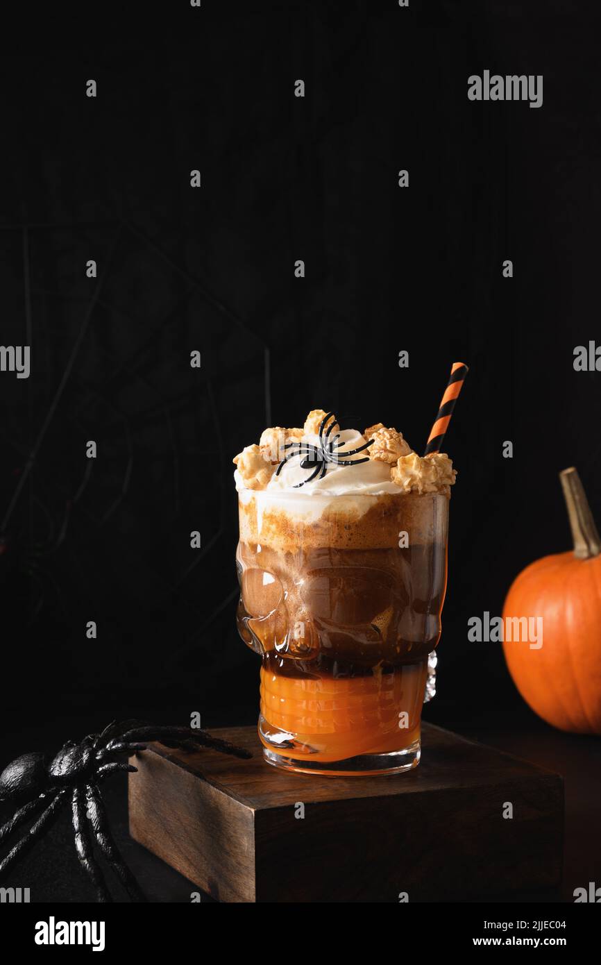 Halloween Pumpkin spice coffee latte decorated spider and popcorn in ...