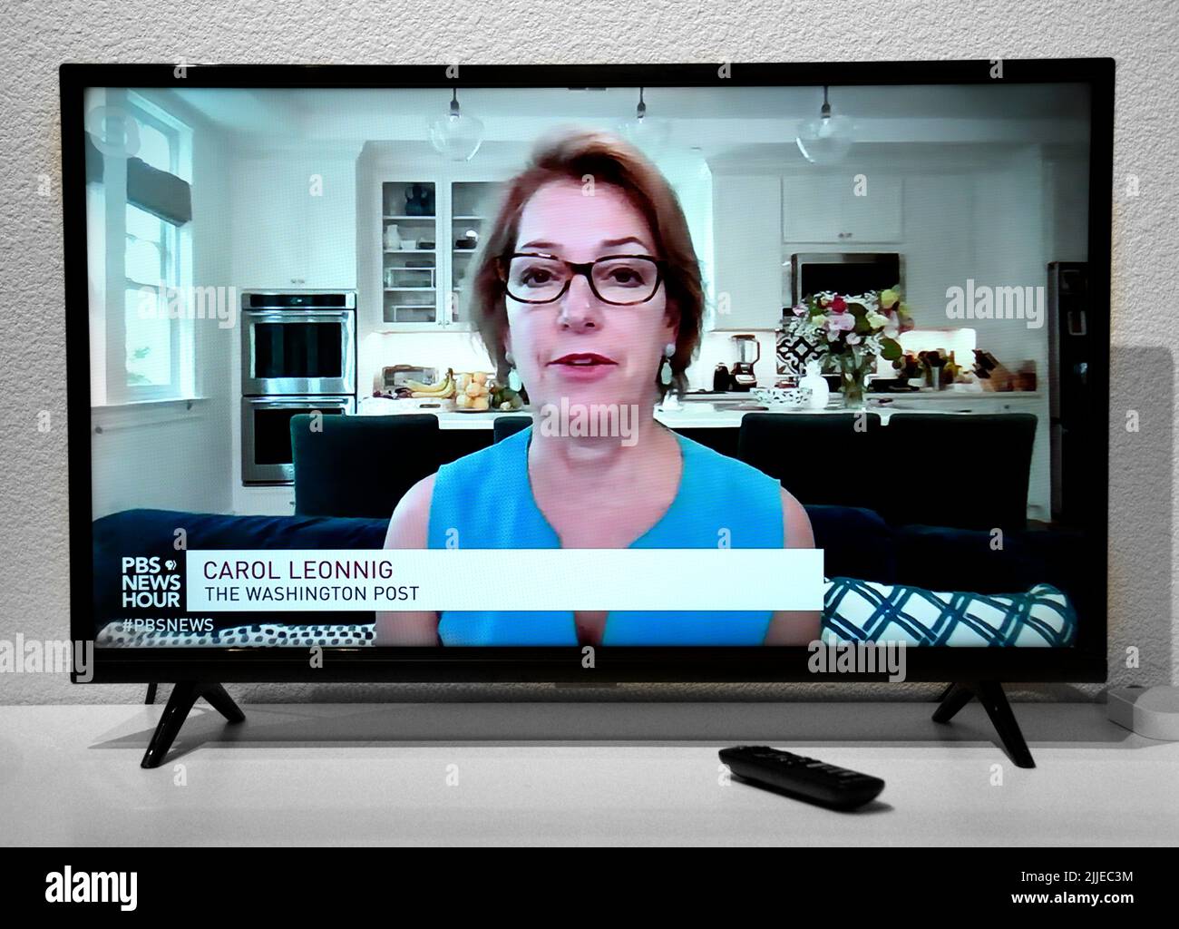 A television screenshot taken during a PBS NewsHour interview with ...