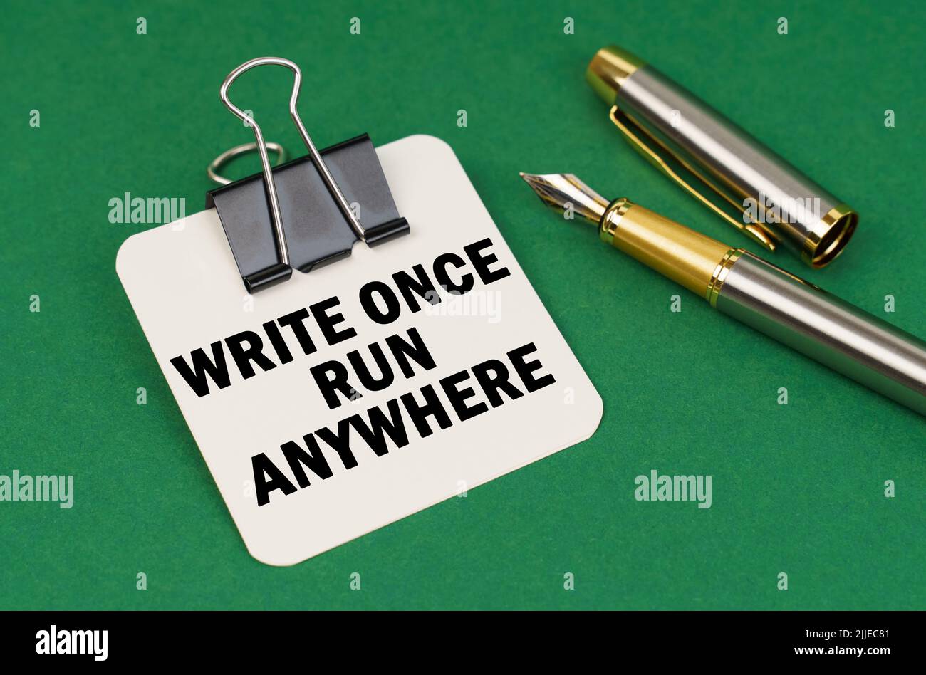 Business and industry concept. On a green surface, a pen and a sheet of ...