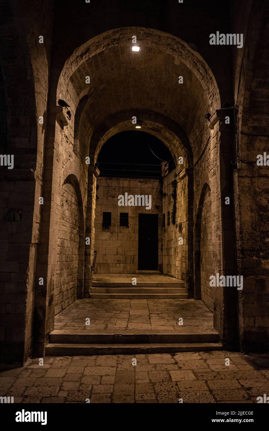 Iconic empty alleyway at night somewhere in the center of Bari ...