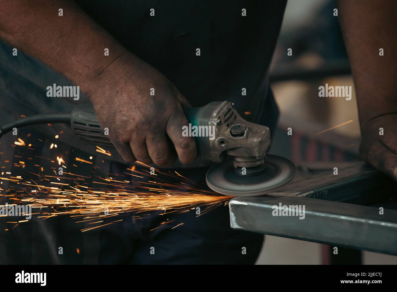 Profesional fabric worker cutting metal profile on the work table with ...