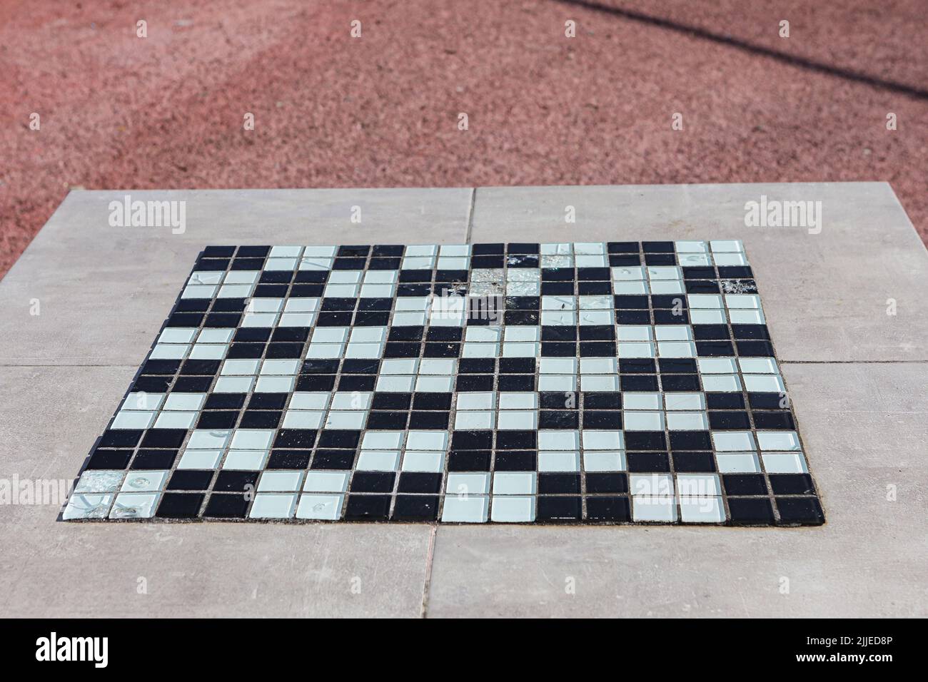 Chess or checker board made with pieces of glass, some broken, in white ...