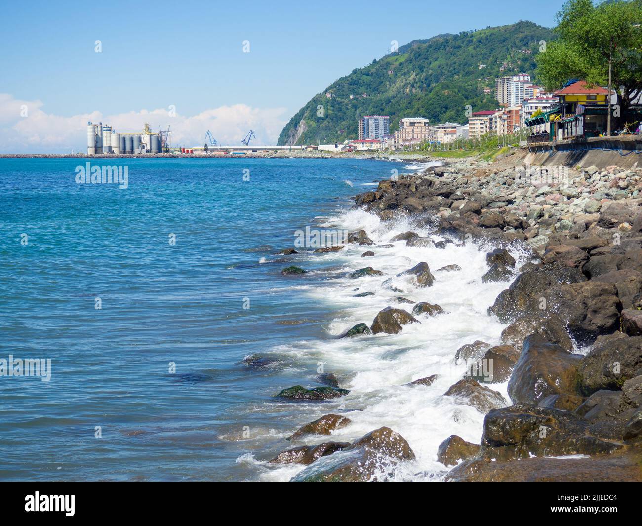 Surf. Waves crash on big rocks. Rocky coast and wave. Fortified ...