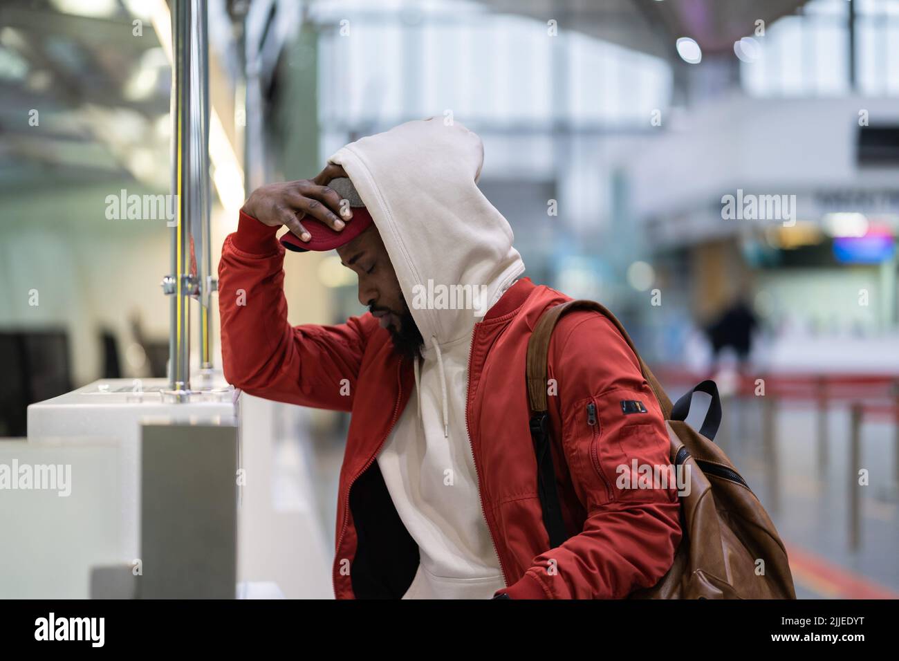 Sad African Man Standing Near Check In Desk Feeling Frustrated Because