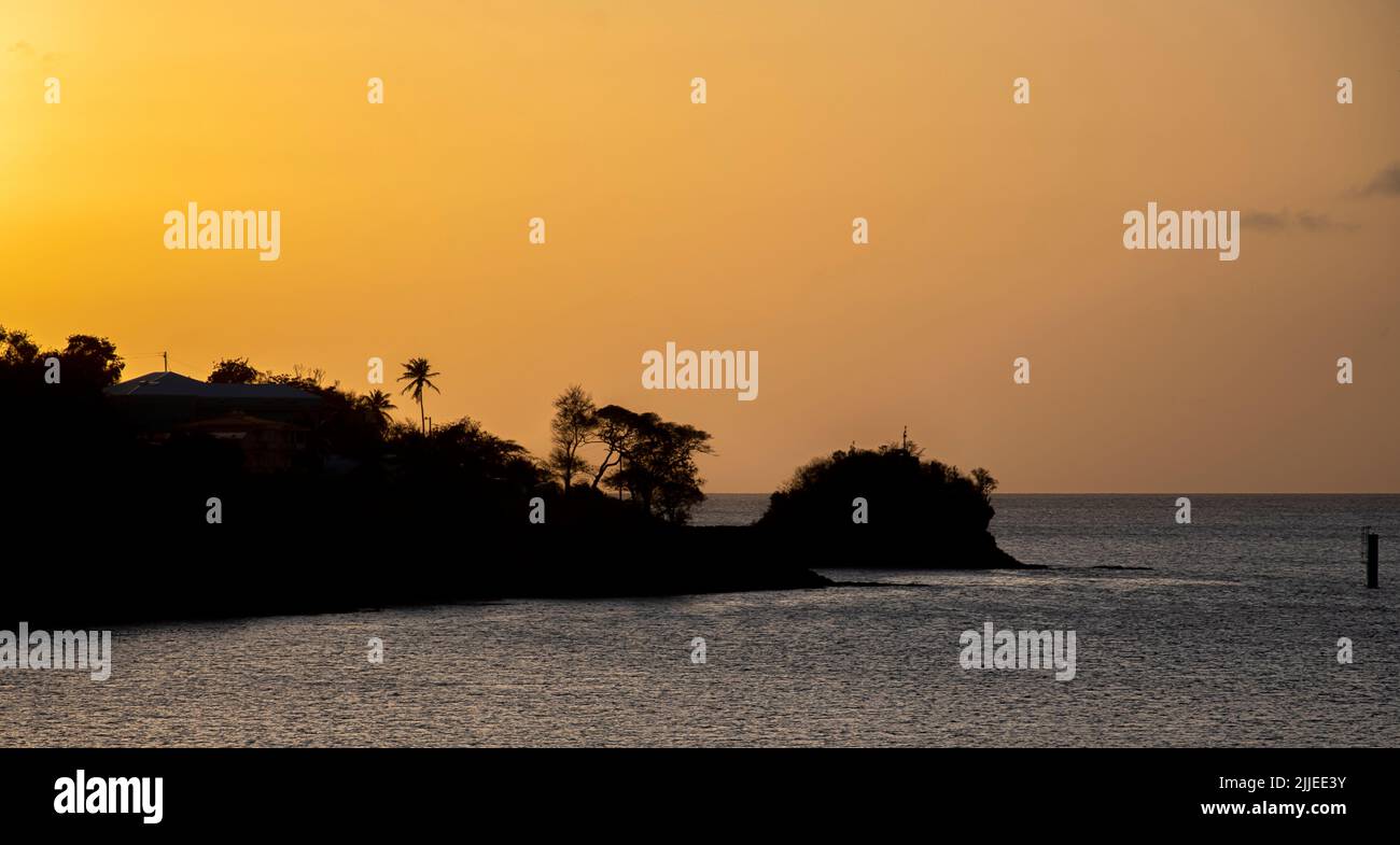 The sun setting behind the island of St Lucia Stock Photo - Alamy